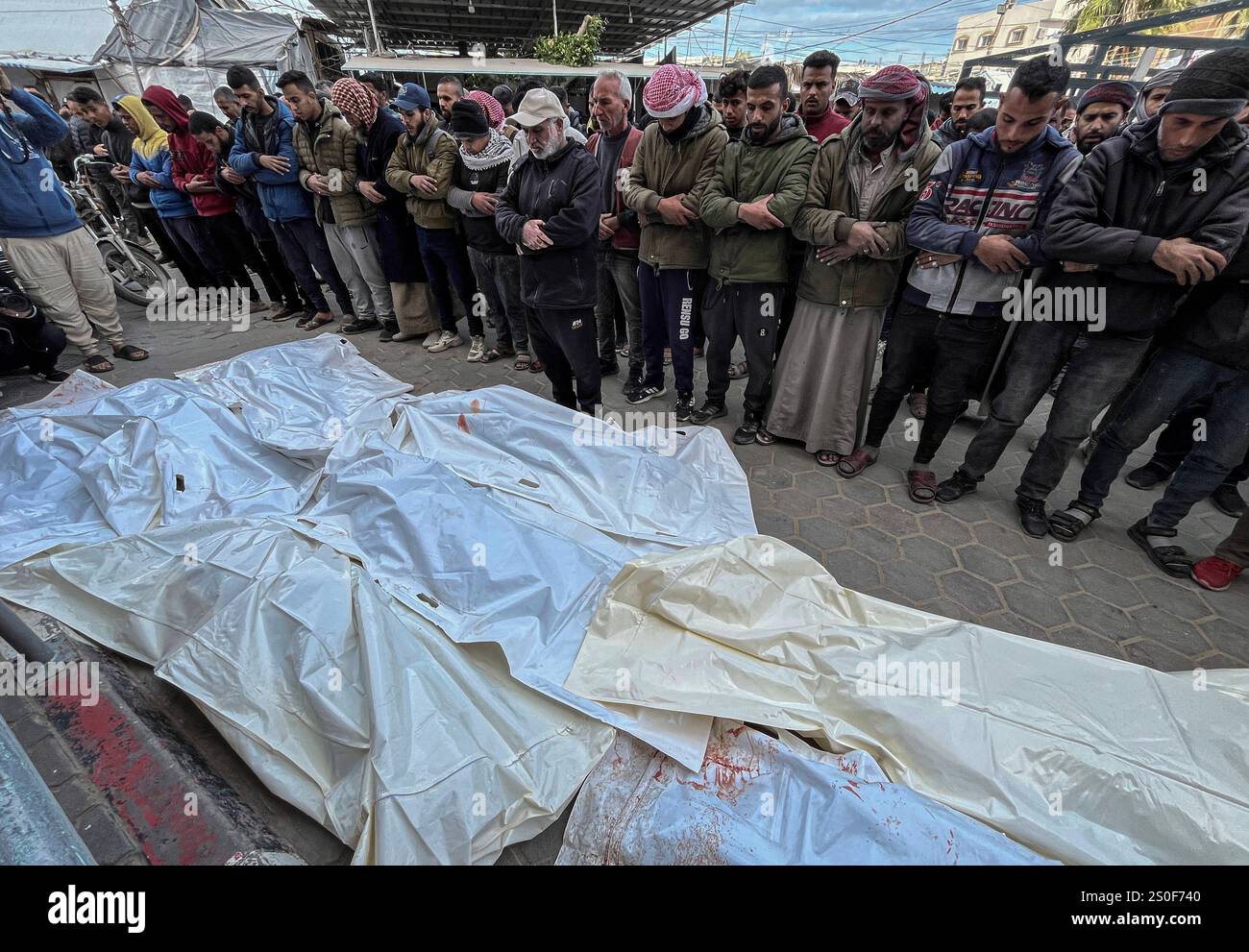 Relatives of the Palestinians died in Israeli attacks, mourn as they ...