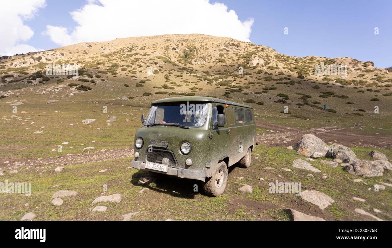 a UAZ-452 vehicle is park in valley of Altyn Arashan area. it is a family of four wheel drive ...