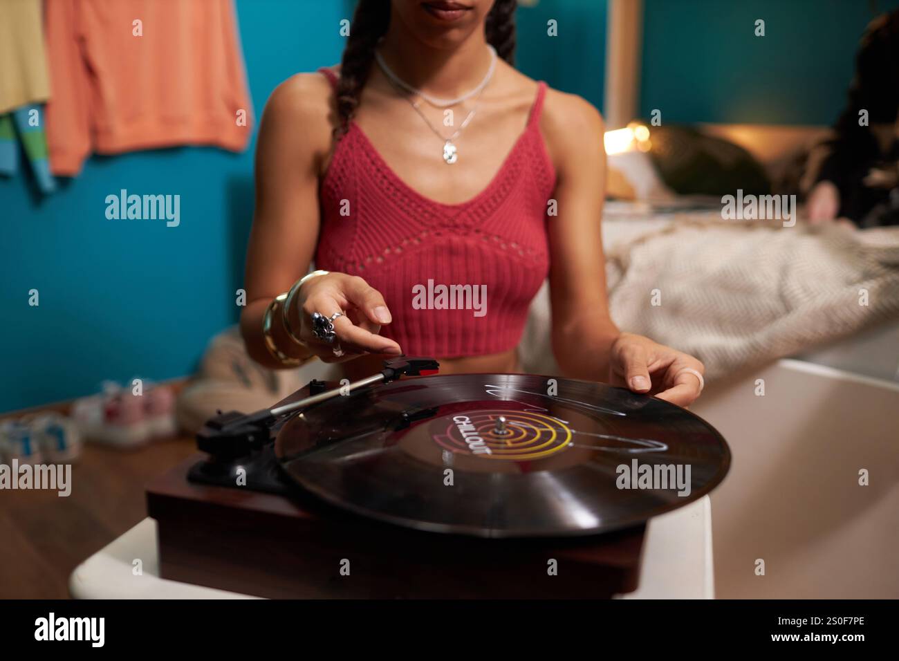 Girl Turning On Music In Dorm Room Stock Photo - Alamy
