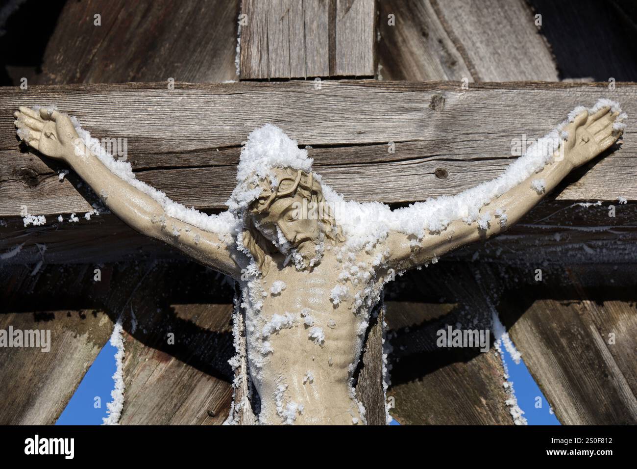 Close-up of the snowy and icy figure of the crucified Jesus Christ in ...