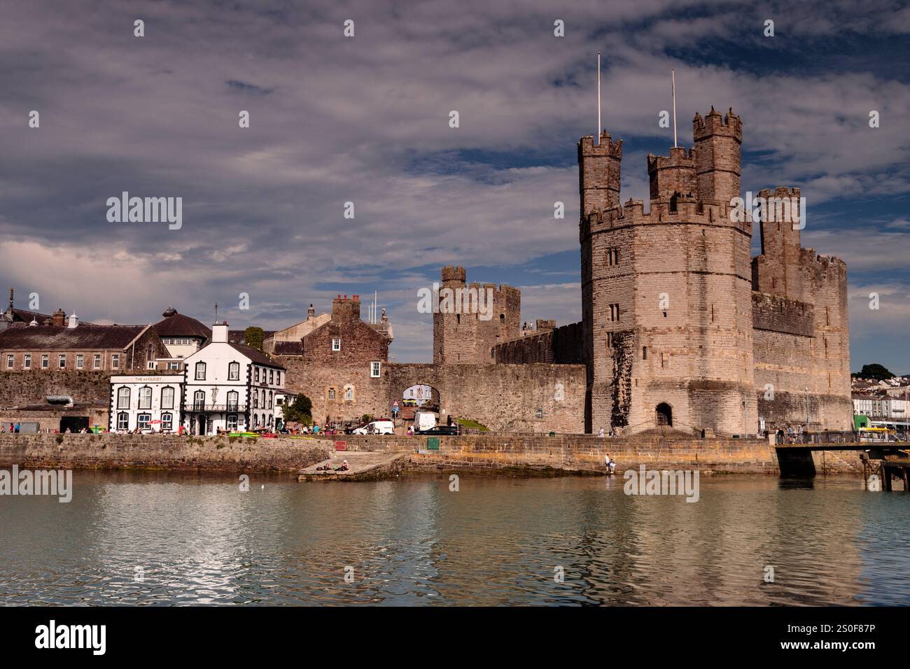 Caernarfon castle reflecting in the waters of the Menai Straits at high ...