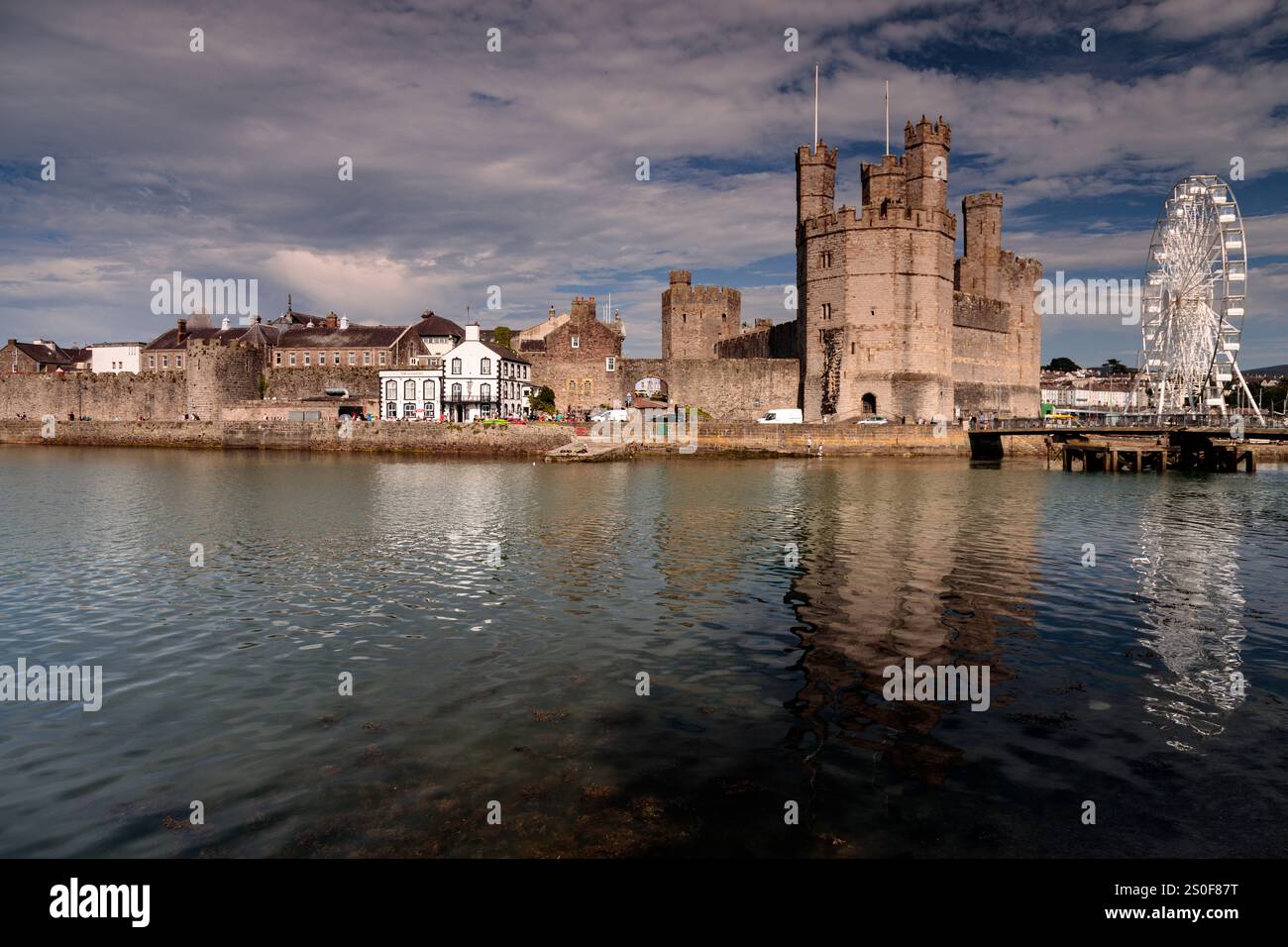 Caernarfon castle reflecting in the waters of the Menai Straits at high ...