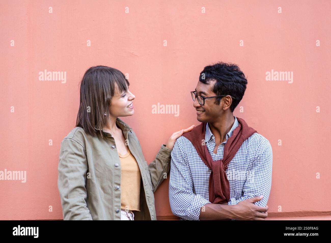 Friendly conversation between two young people of different ethnicities ...