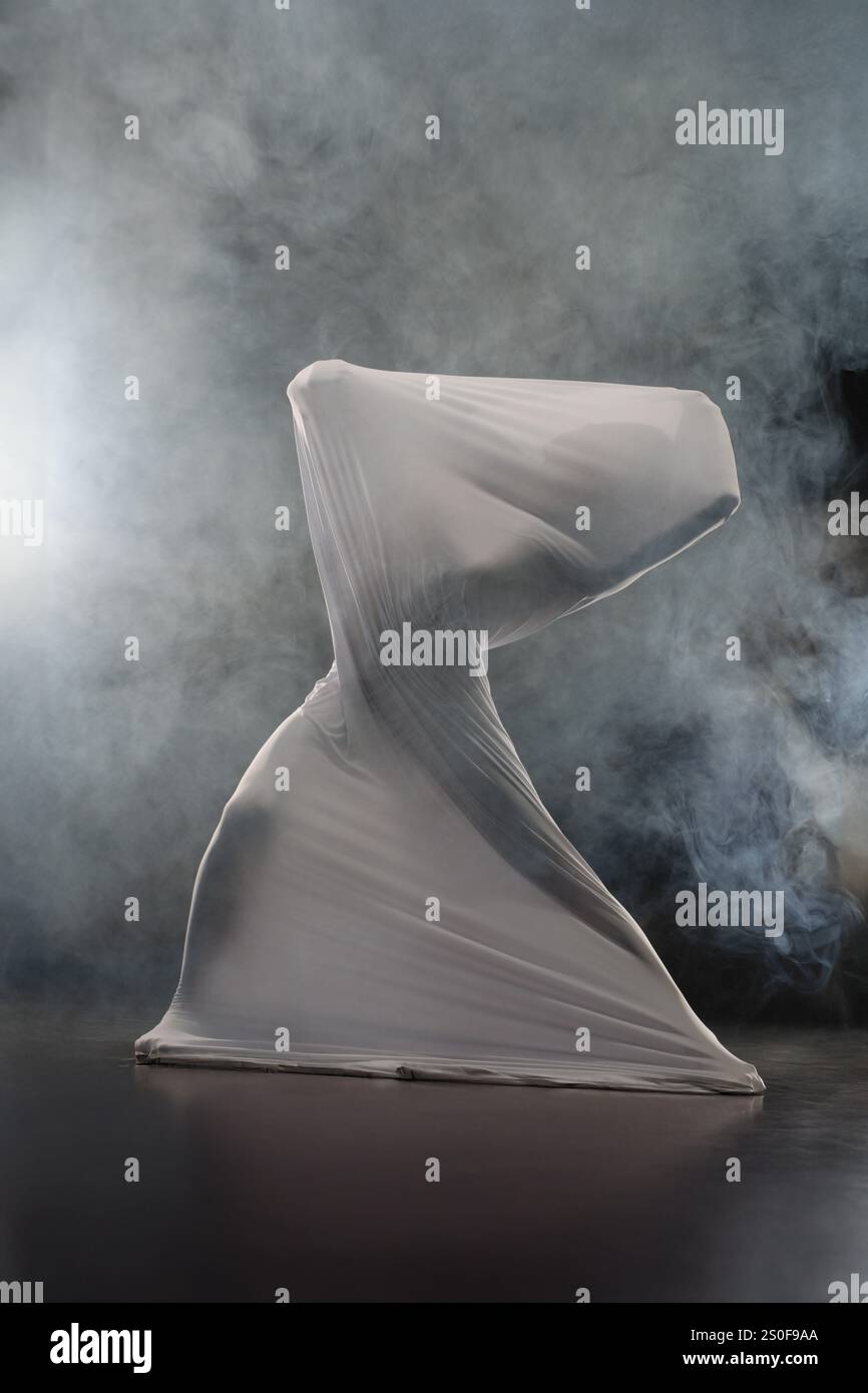 Artistic representation of a cloaked figure emerging from mist Stock ...