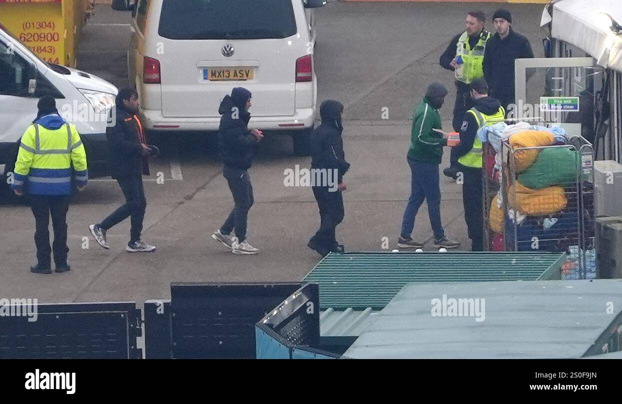 A group of people thought to be migrants are brought in to Dover, Kent ...