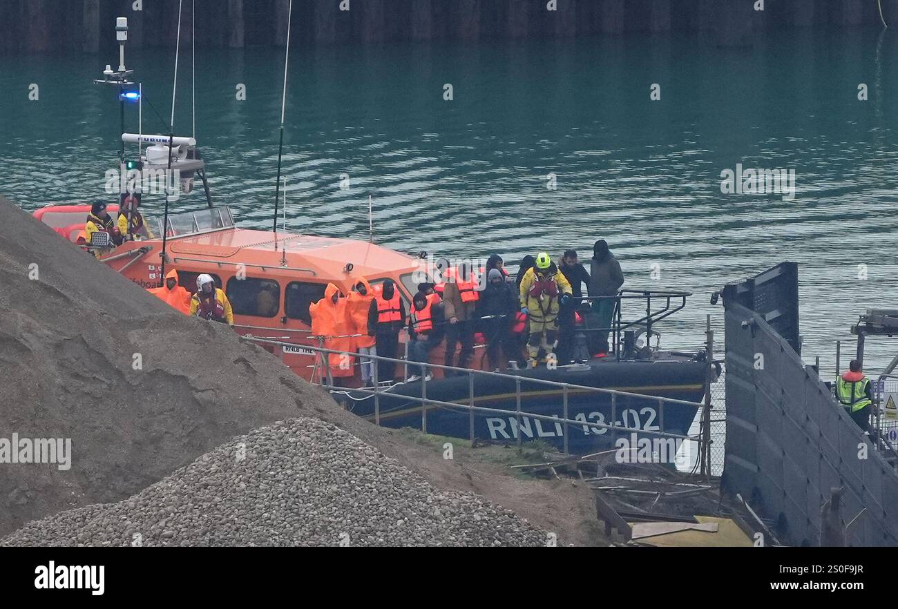 A group of people thought to be migrants are brought in to Dover, Kent ...