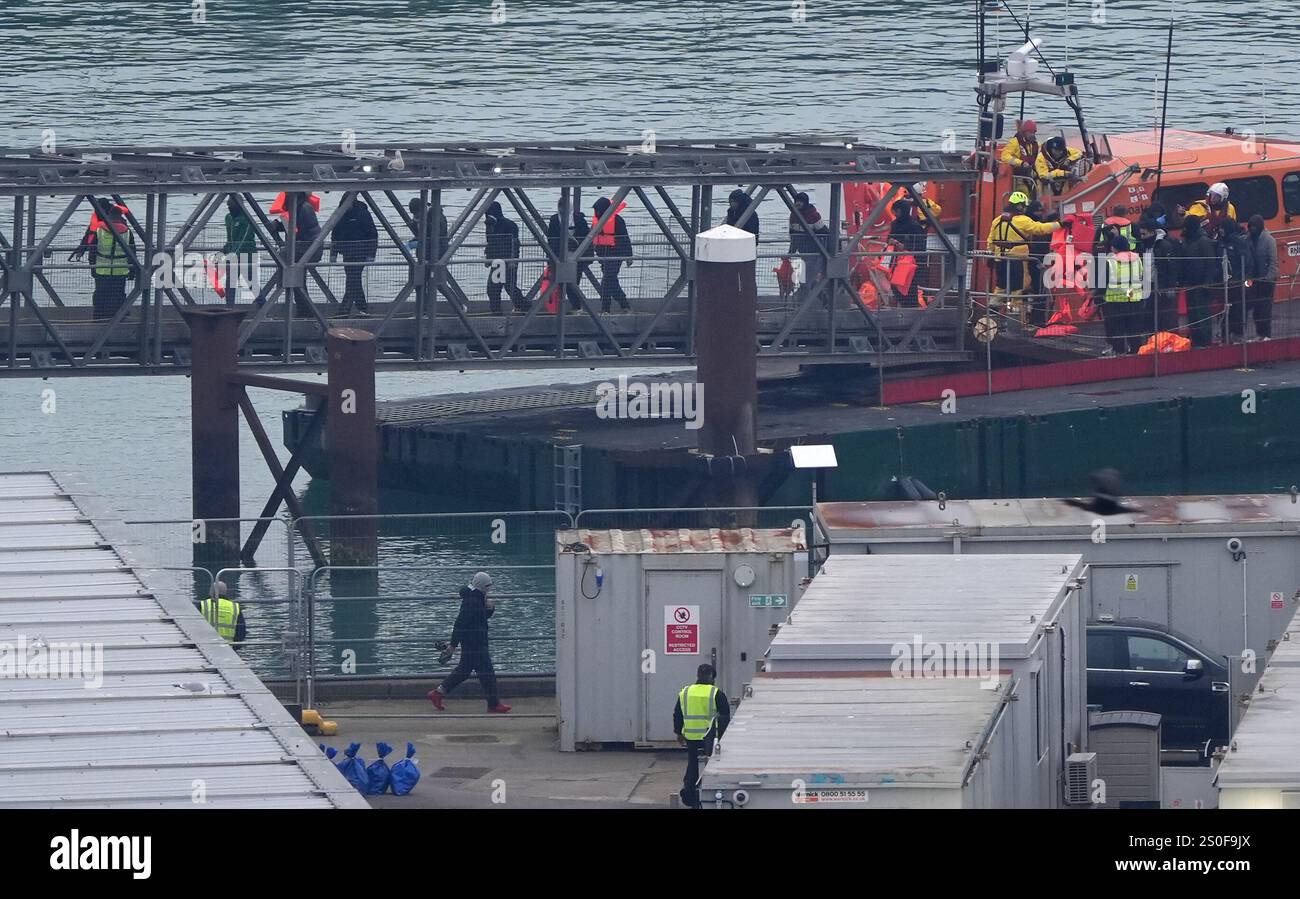 A group of people thought to be migrants are brought in to Dover, Kent ...
