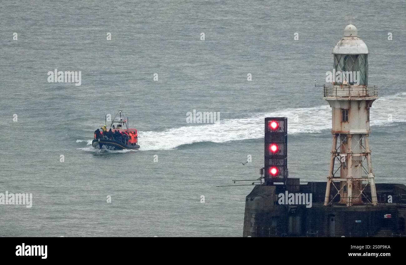 A group of people thought to be migrants are brought in to Dover, Kent ...