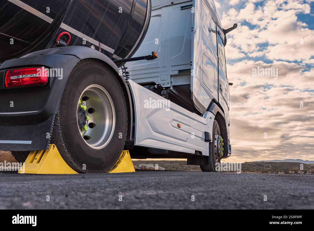 Wheel chocks placed on the drive wheel of a tanker truck to immobilize ...