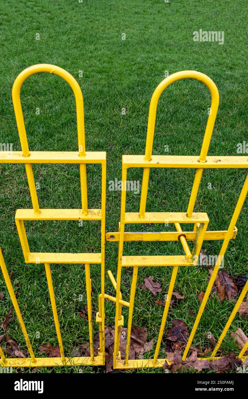 Yellow painted closed metal gate Stock Photo - Alamy