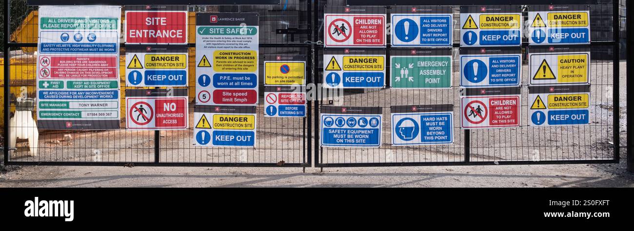 A construction site entrance gate with an array of building rules and ...