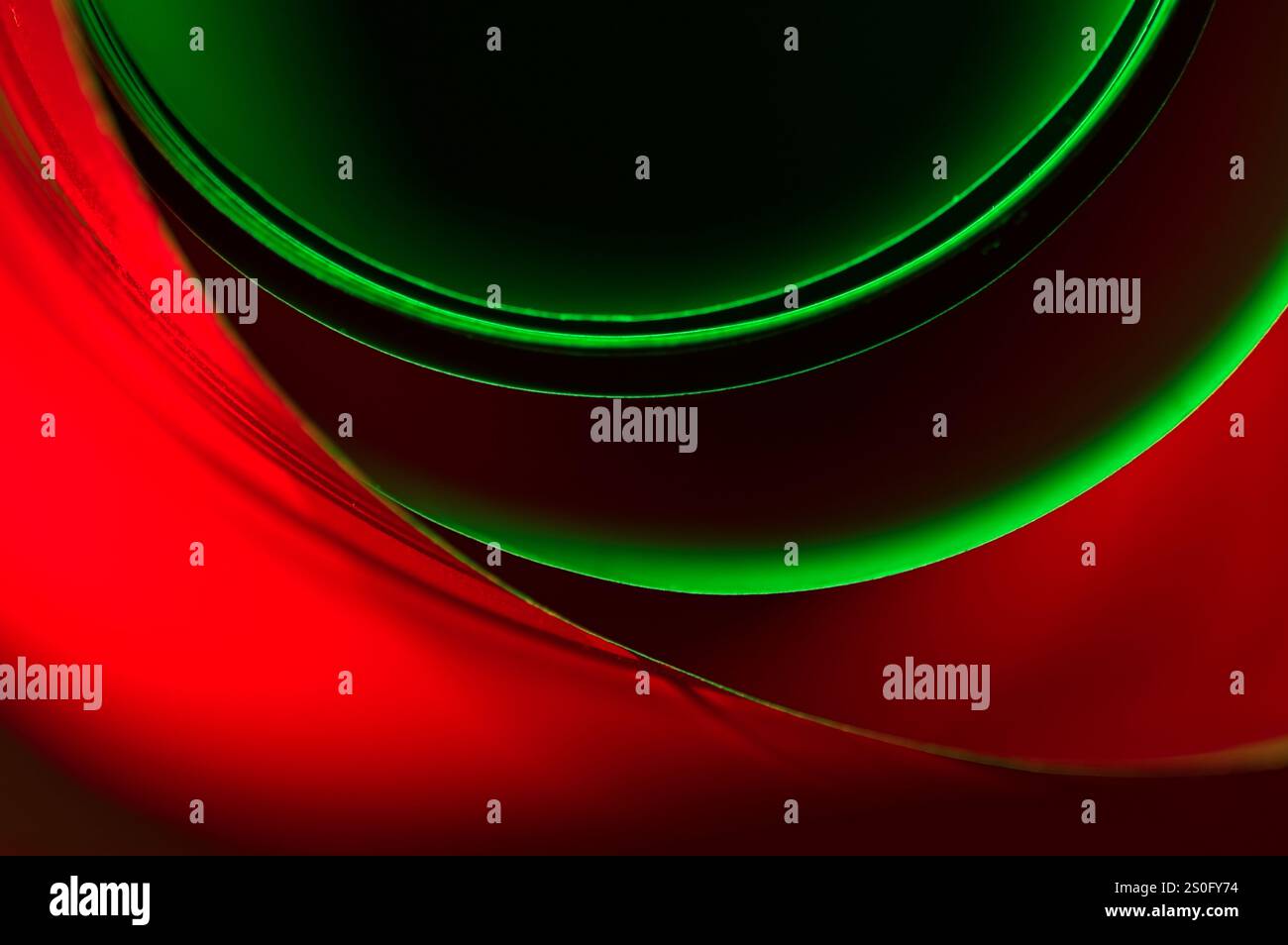 Abstract view of end of a roll of paper with red and green glowing ...