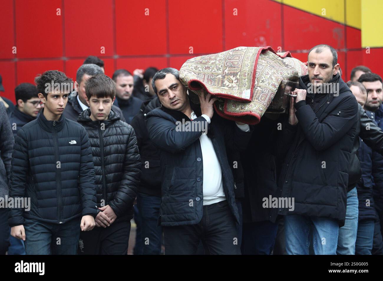 People attend a funeral of Mahammadali Eganov who died in the Azerbaijan Airlines Embraer 190 ...