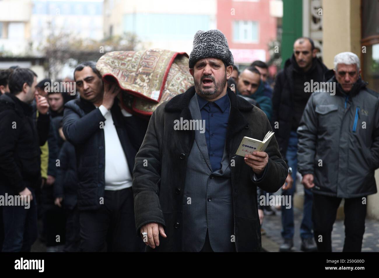 People attend a funeral of Mahammadali Eganov who died in the Azerbaijan Airlines Embraer 190 ...