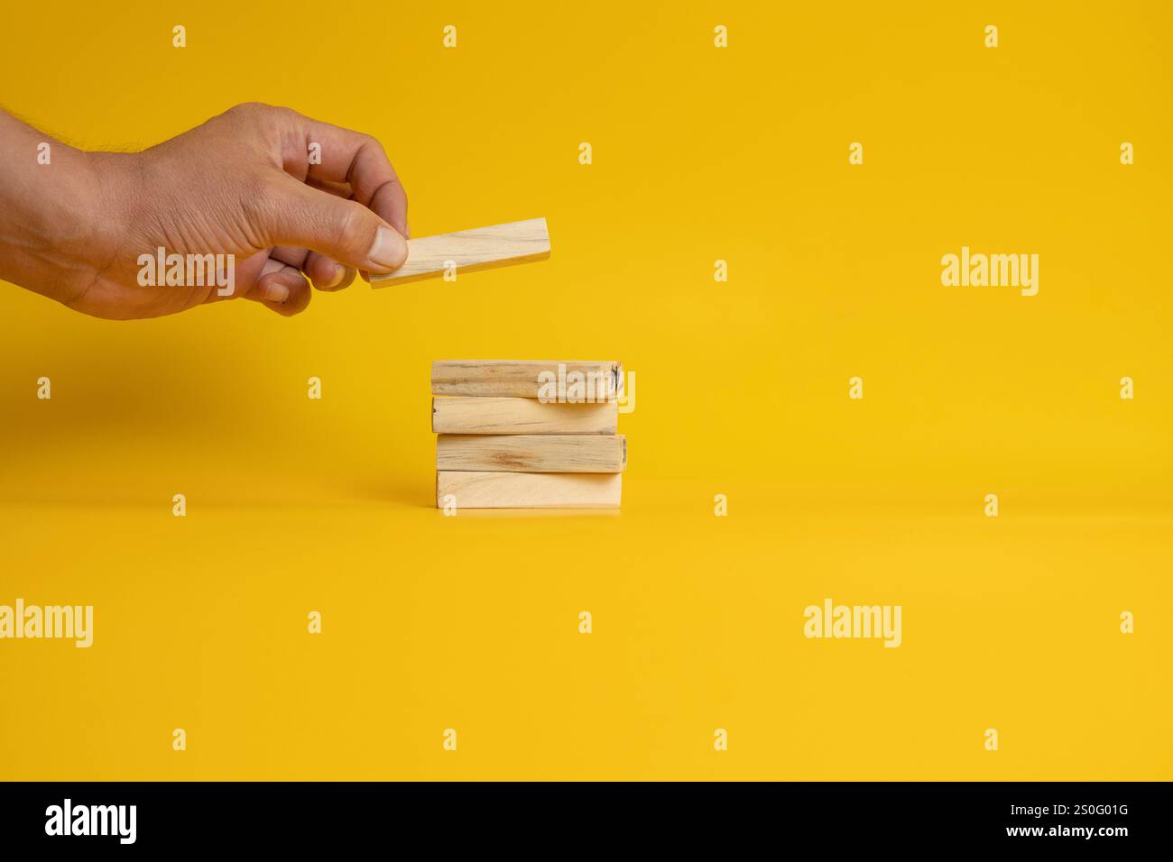 An image featuring three wooden Jenga blocks arranged neatly on a solid ...