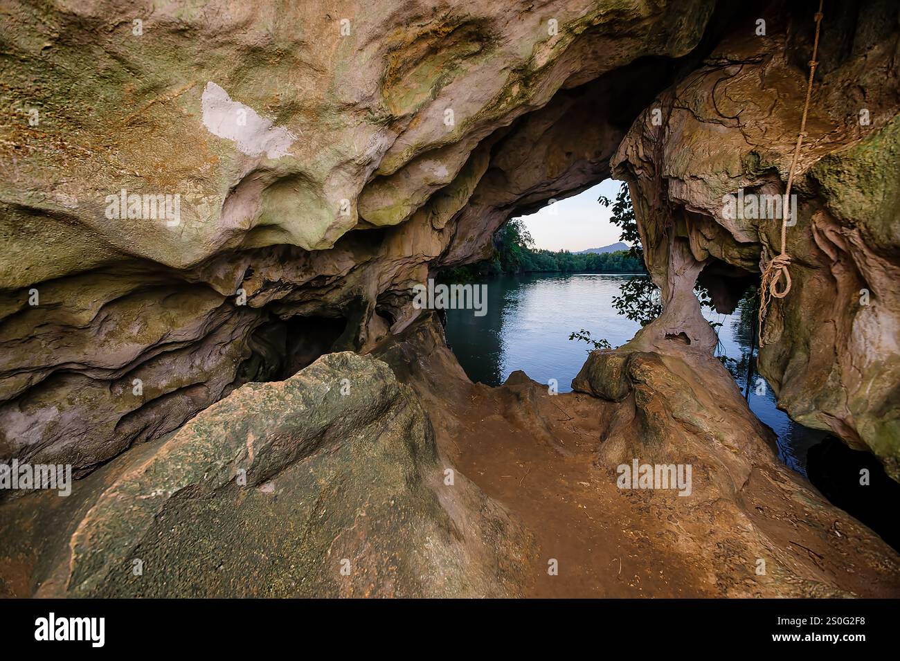 a cave with stalagmites and stalactites. The cave is large and dark ...
