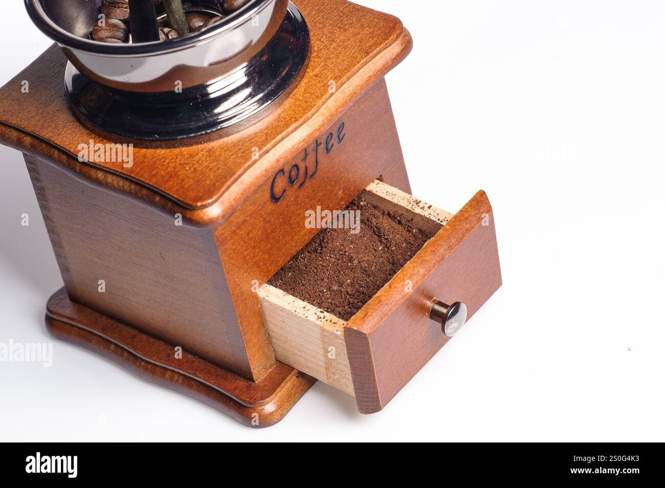 grounded coffee from the grinding machine with some coffee beans before ...