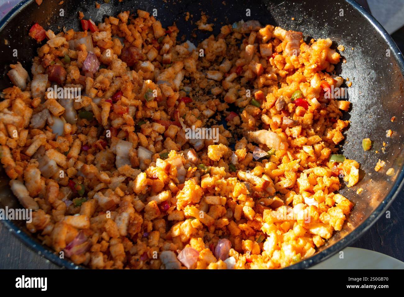 Preparing La Mancha or Castilian migas as a family where everyone eats ...