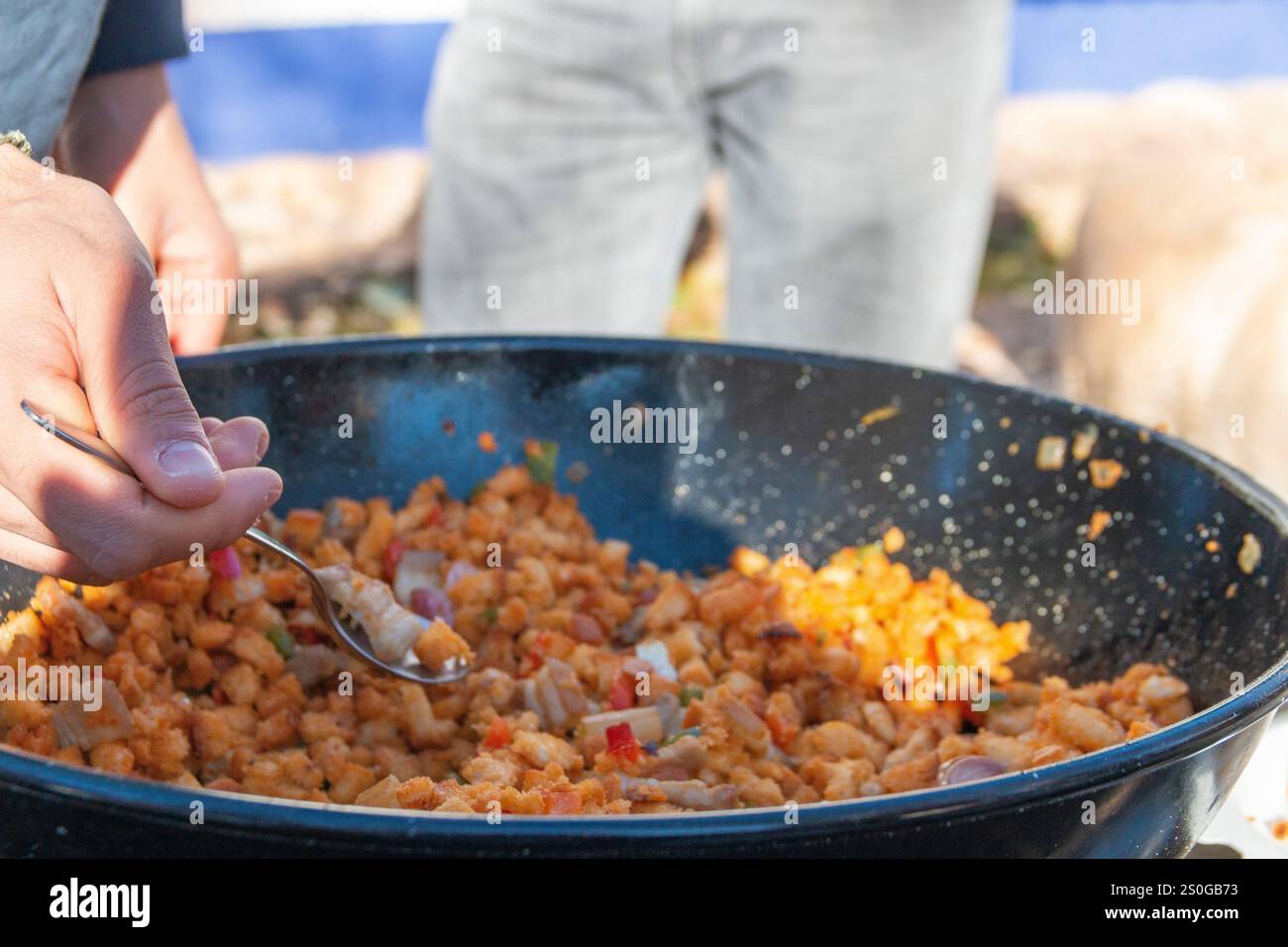 Preparing La Mancha or Castilian migas as a family where everyone eats ...