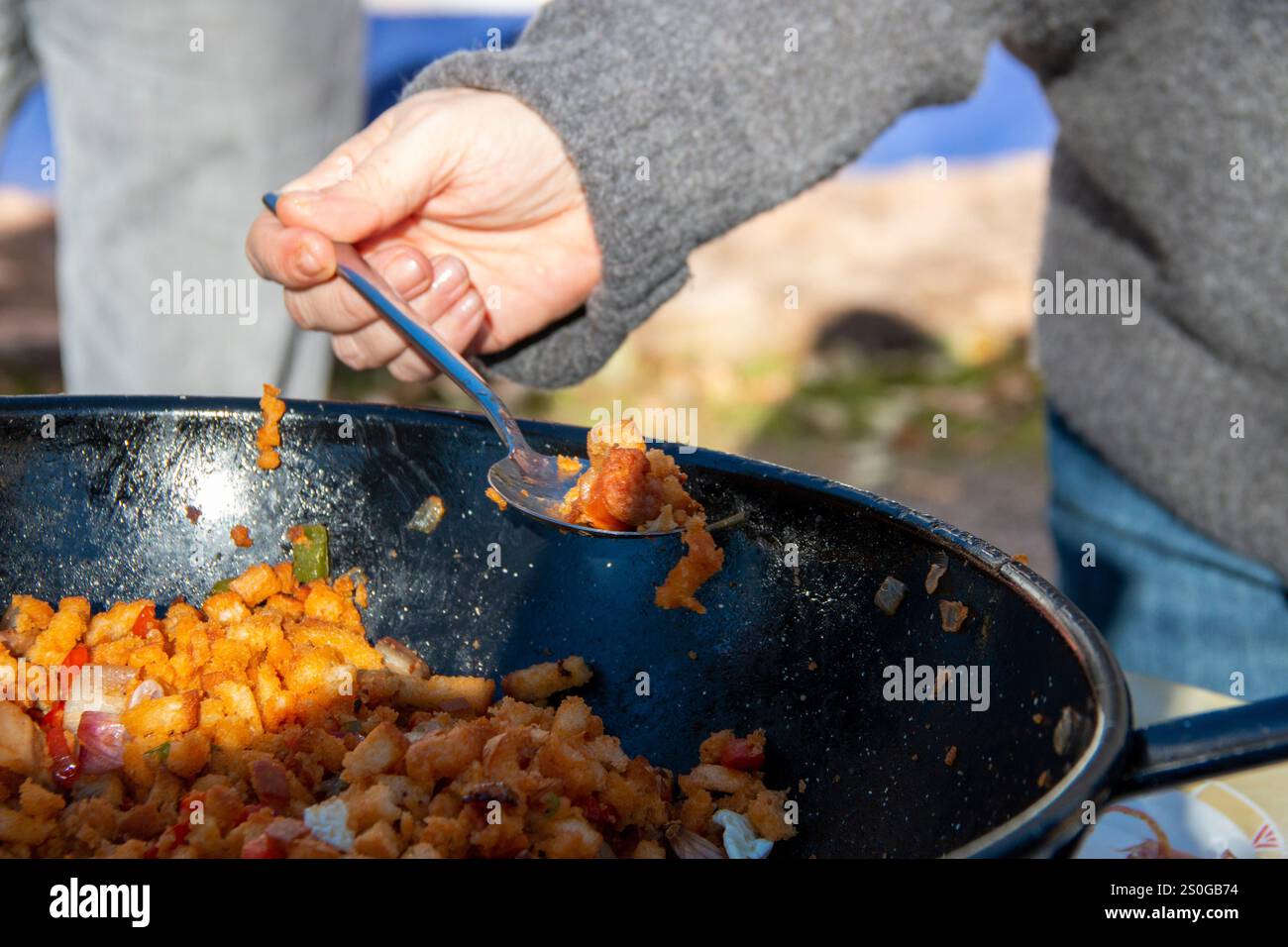 Preparing La Mancha or Castilian migas as a family where everyone eats ...