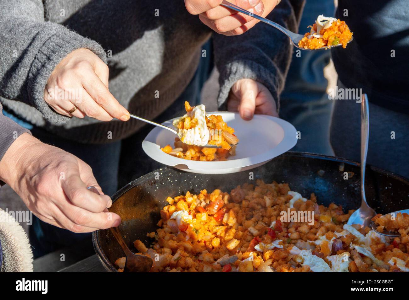 Preparing La Mancha or Castilian migas as a family where everyone eats ...