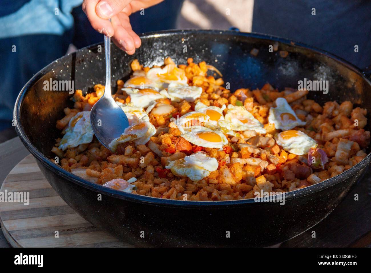 Preparing La Mancha or Castilian migas as a family where everyone eats ...