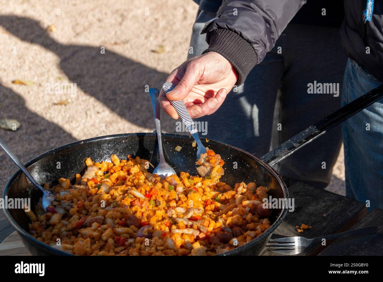 Preparing La Mancha or Castilian migas as a family where everyone eats ...