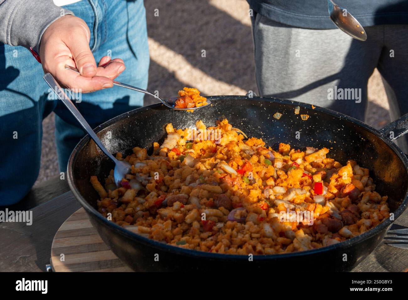 Preparing La Mancha or Castilian migas as a family where everyone eats ...