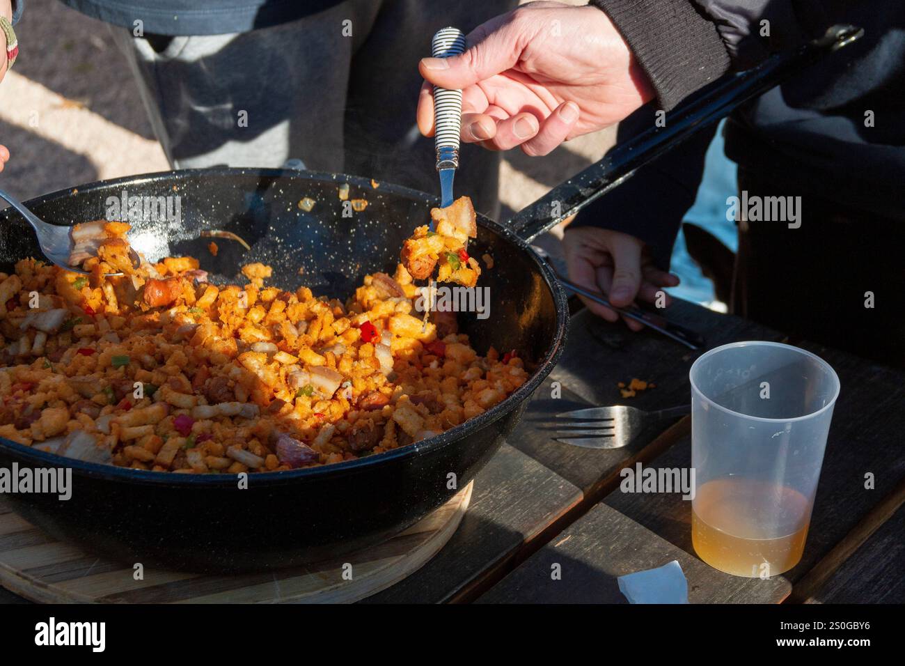 Preparing La Mancha or Castilian migas as a family where everyone eats ...