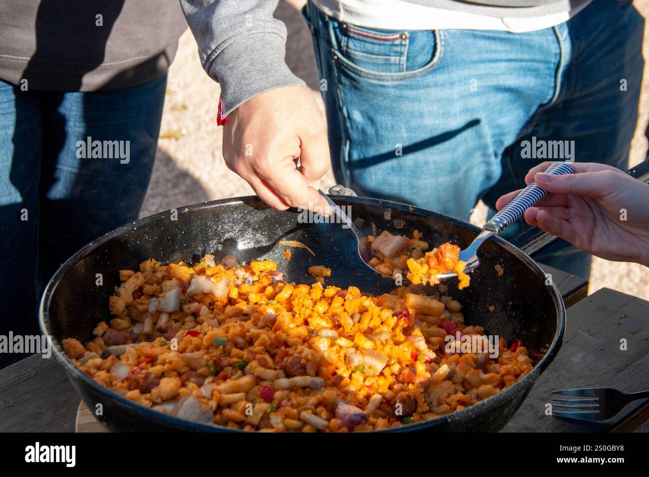 Preparing La Mancha or Castilian migas as a family where everyone eats ...