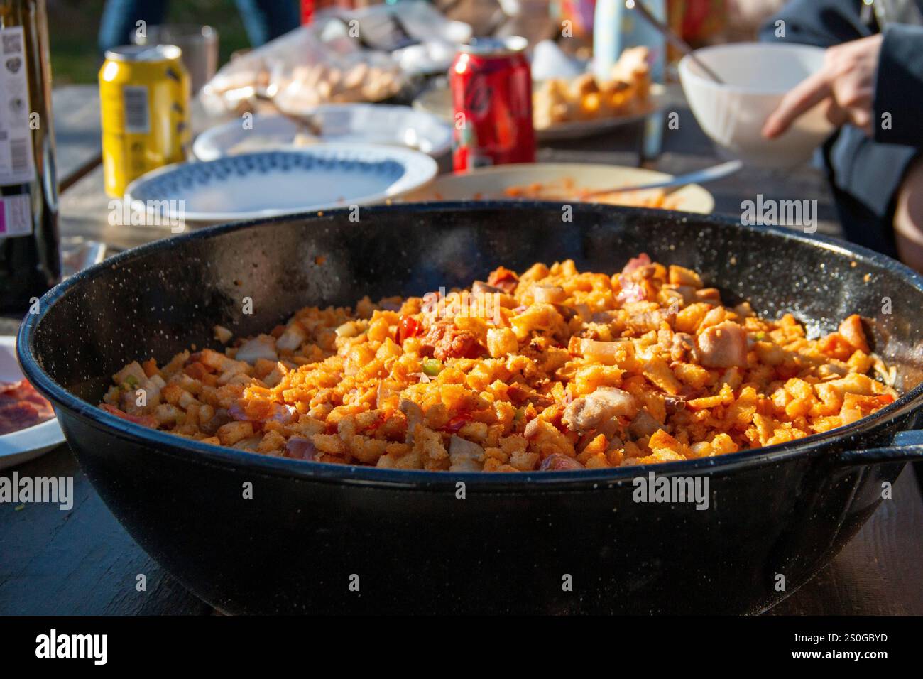 Preparing La Mancha or Castilian migas as a family where everyone eats ...