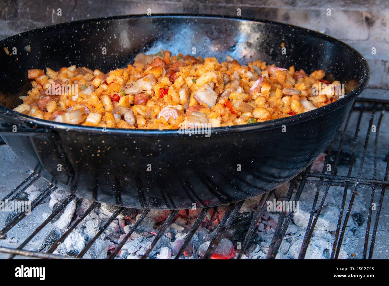 Preparing La Mancha or Castilian migas as a family where everyone eats ...