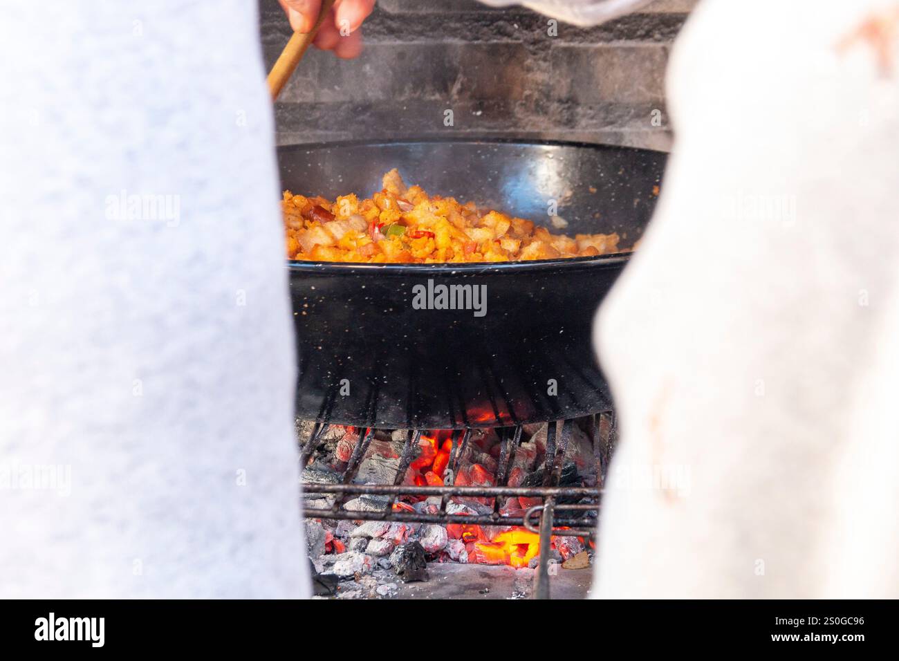 Preparing La Mancha or Castilian migas as a family where everyone eats ...