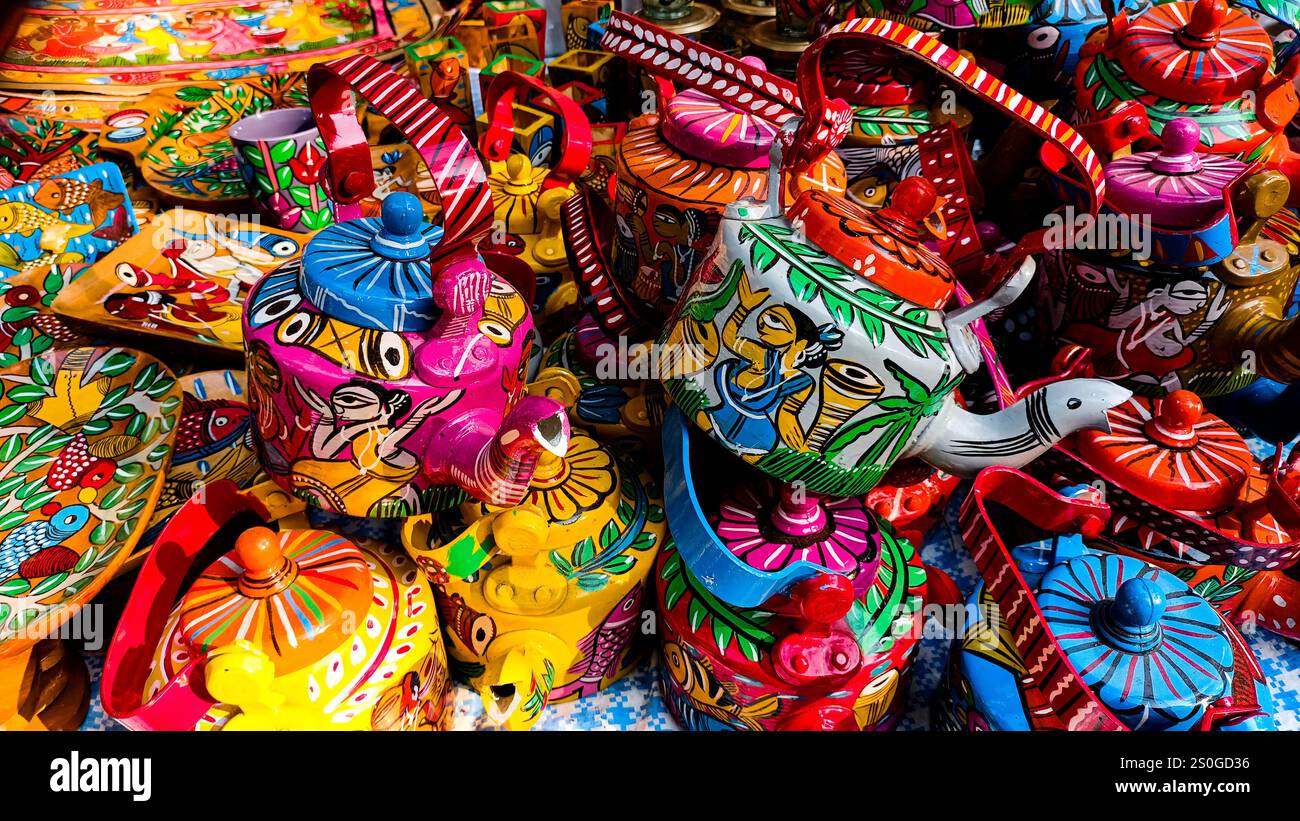 A close-up shot of hand-painted metal kettles crafted by artisans from ...
