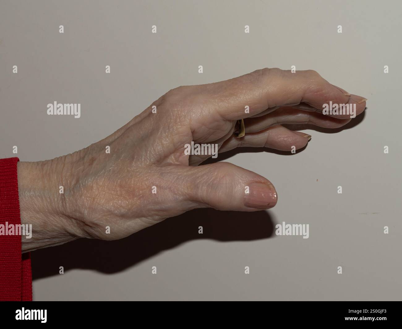 elderly woman's hand showcasing detailed skin texture, adorned with a ...