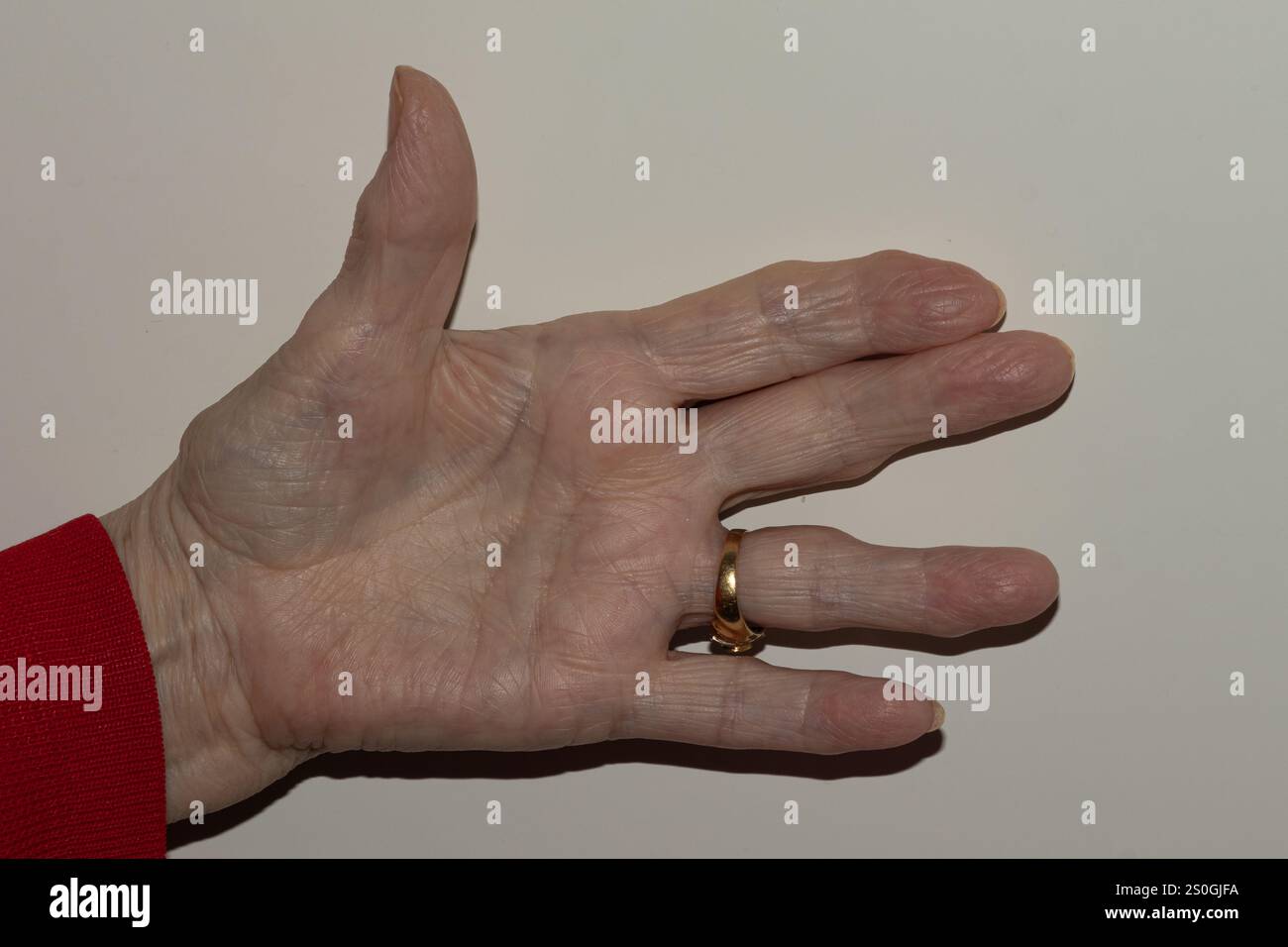 Detailed close-up of a senior woman's fully open hand, highlighting the ...