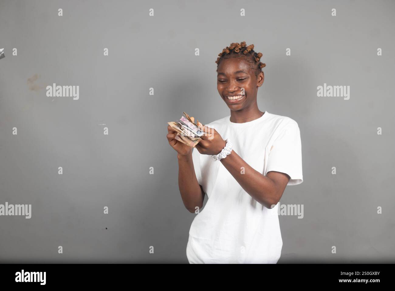 pretty Nigerian lady counting money with a smile on her face Stock ...
