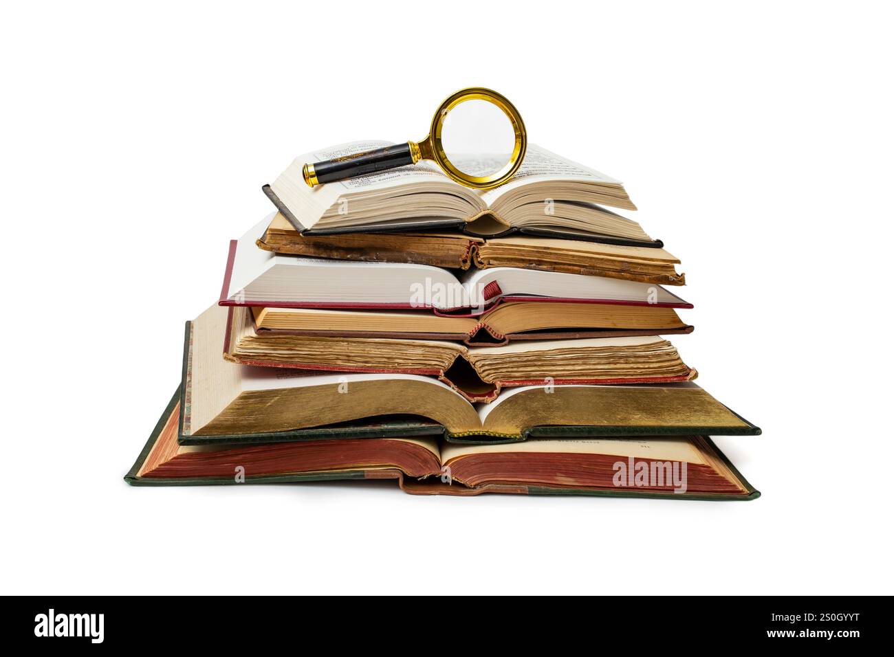 Vintage hard cover books opened and stacked with a magnifying glass on ...