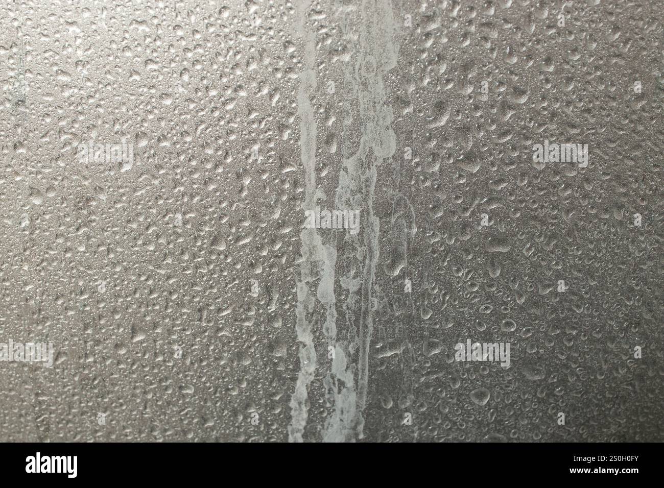 Limescale trails from hard water issue and water drops, on metallic ...