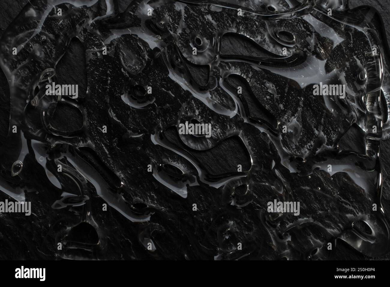 Hot glue smear on black background, abstract textured pattern, close up ...
