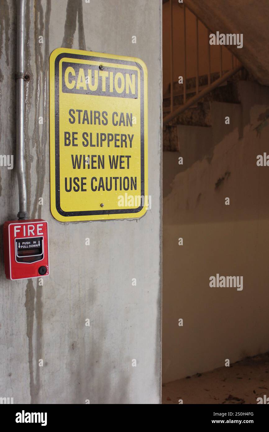 Warning Sign in Parking Garage Caution When Wet Stairs Stock Photo - Alamy