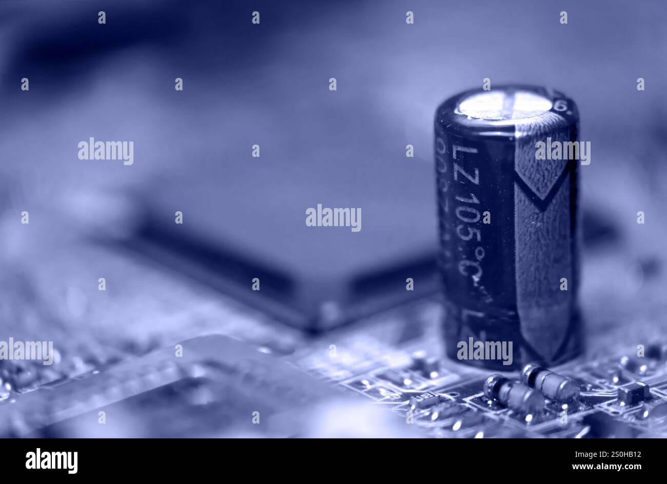 Detail of old capacitor on blue computer motherboard Stock Photo - Alamy
