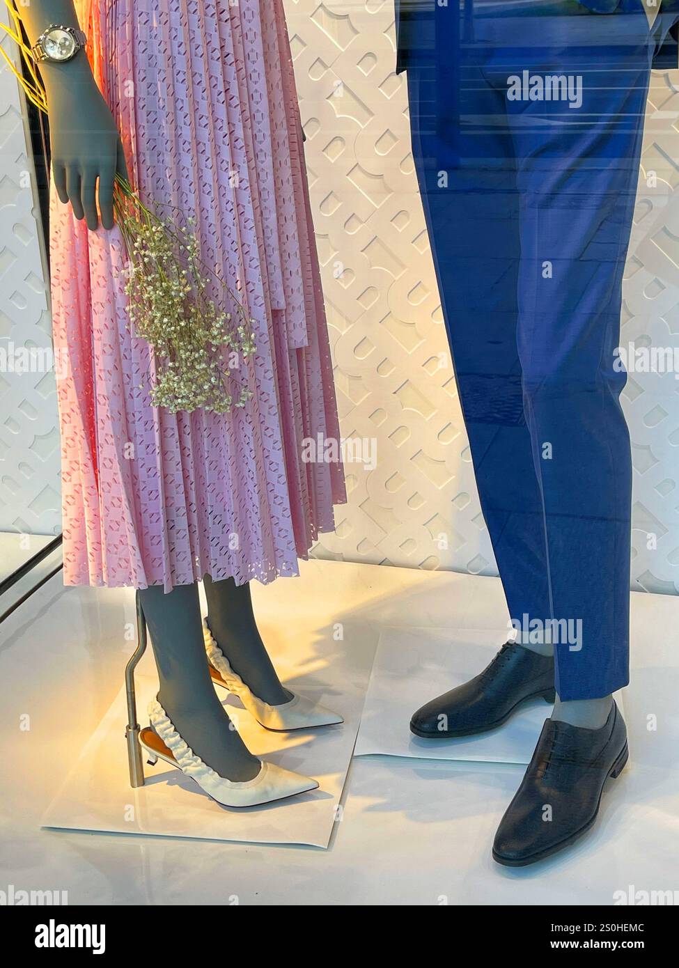 Two mannequins legs in a shop window Stock Photo - Alamy