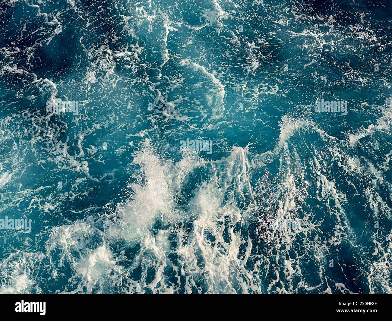 The ocean's waves dance with untamed energy at sunset, capturing the ...