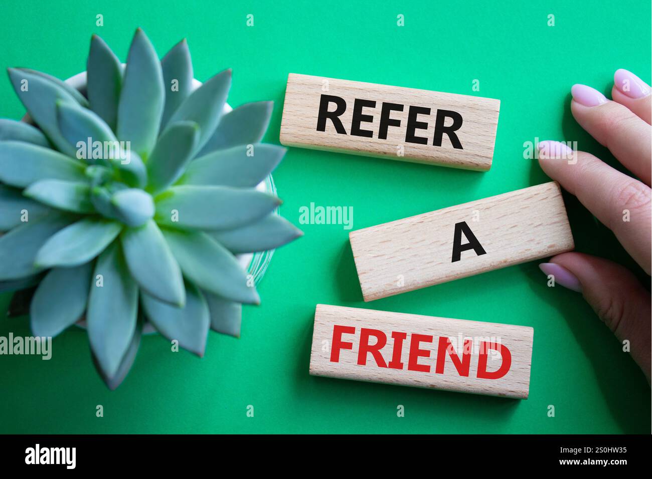 Refer a Friend symbol. Concept words Refer a Friend on wooden blocks ...