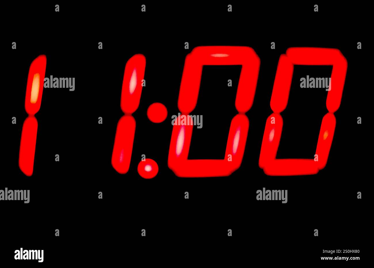 A digital clock face showing the time in red numbers on a black ...