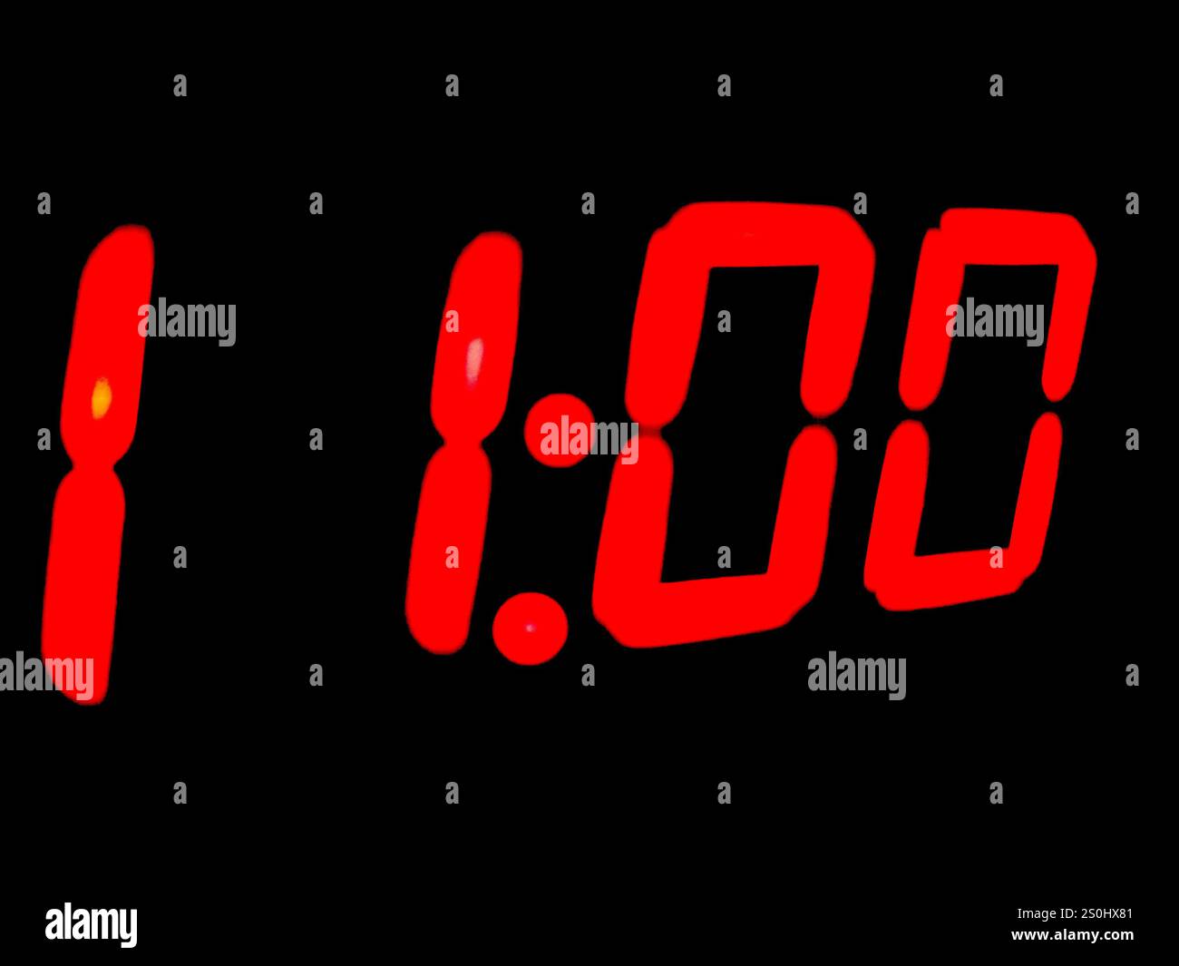 A digital clock face showing the time in red numbers on a black ...