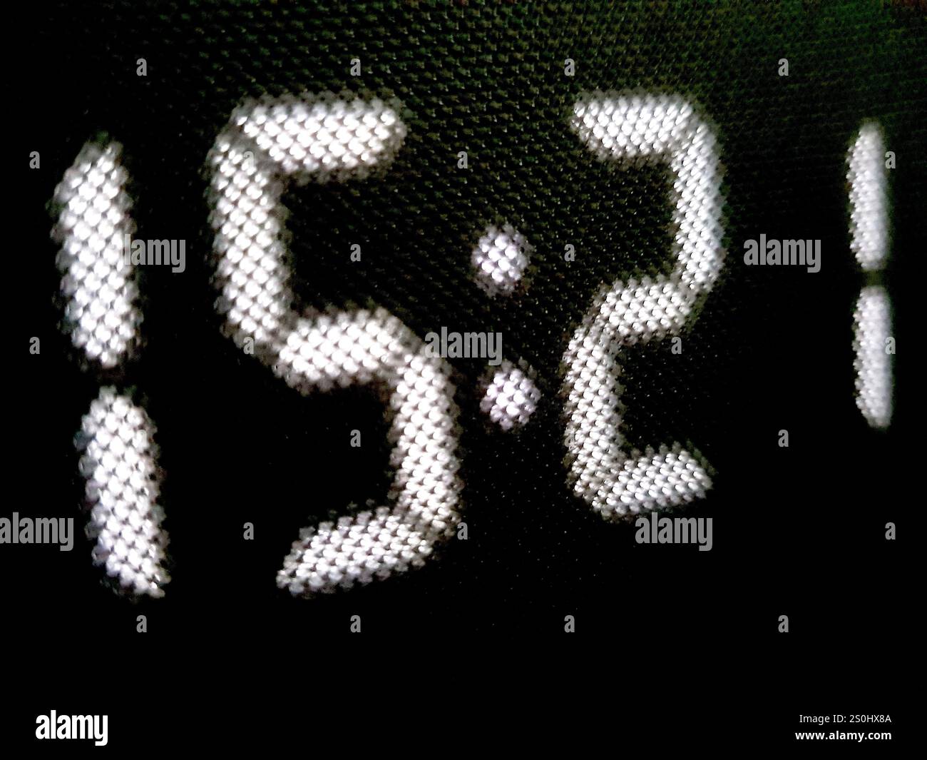 A digital clock face showing the time in white numbers on a black ...