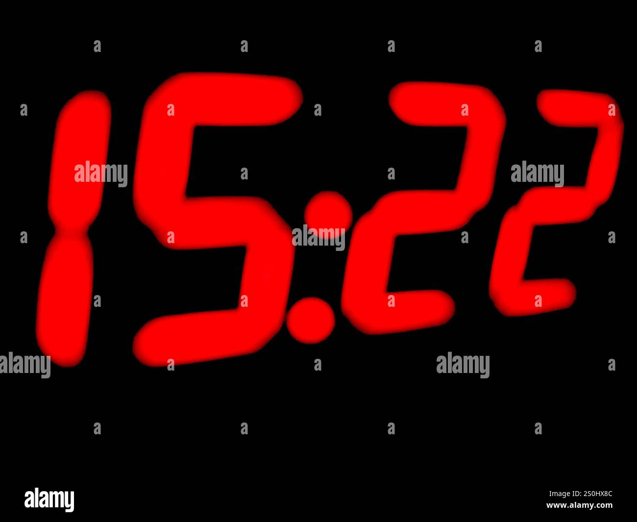 A digital clock face showing the time in red numbers on a black ...