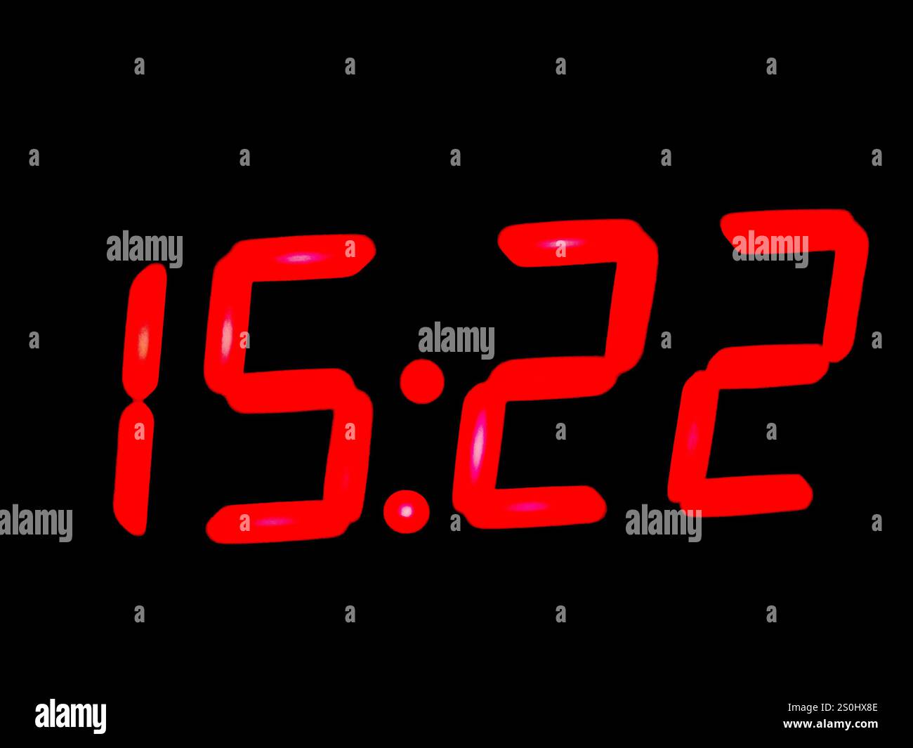 A digital clock face showing the time in red numbers on a black ...